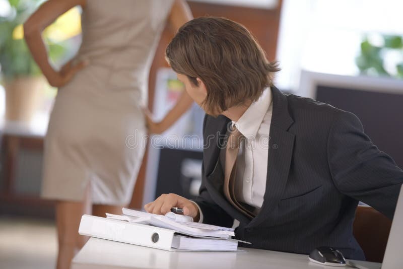 Checking Out Office Interior. Young Man Checking Out a Coworkers Behind ...