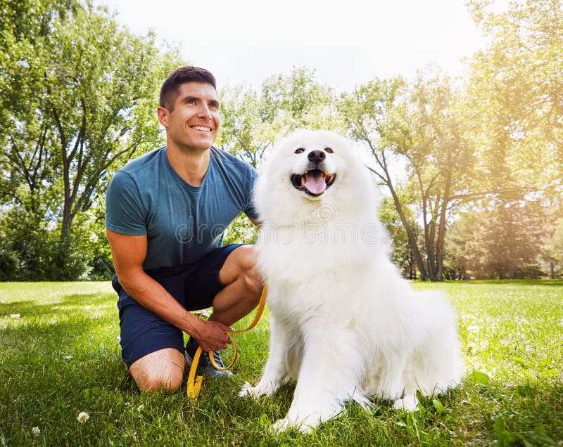 Checking Out the Park Together. a Handsome Young Man Walking His Dog in ...