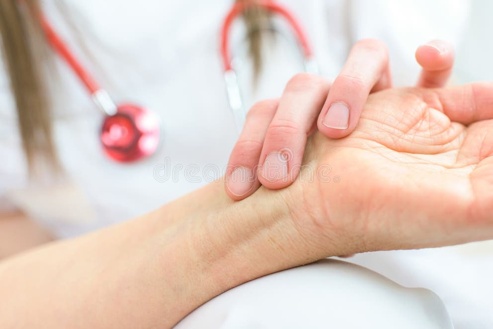 Checking a patient s pulse stock image. Image of hand - 269559695