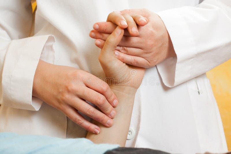 Checking a patients pulse stock image. Image of treating - 11653253