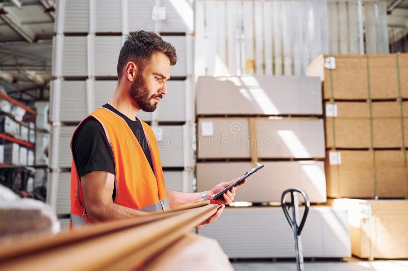 Checking Quality of Product. Storage Worker is in the Warehouse Stock ...