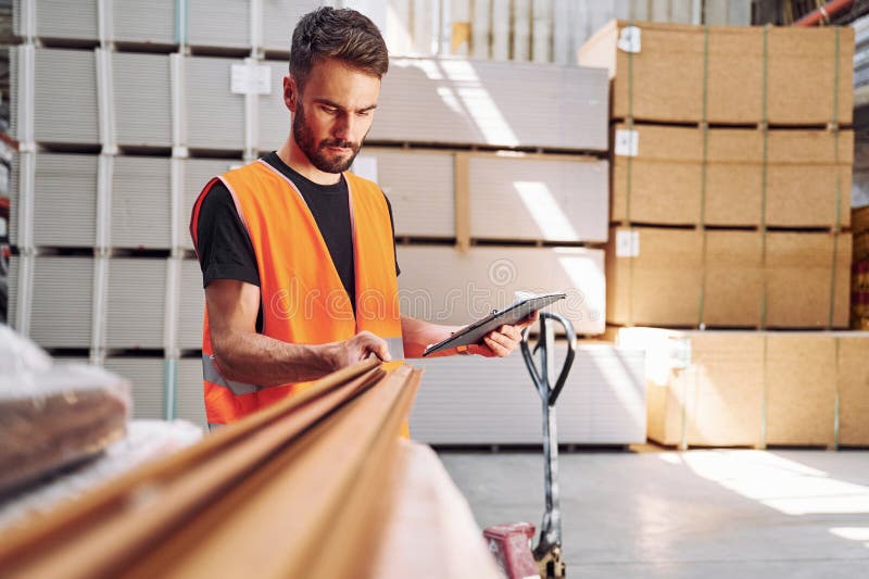 Checking Quality of Product. Storage Worker is in the Warehouse Stock ...