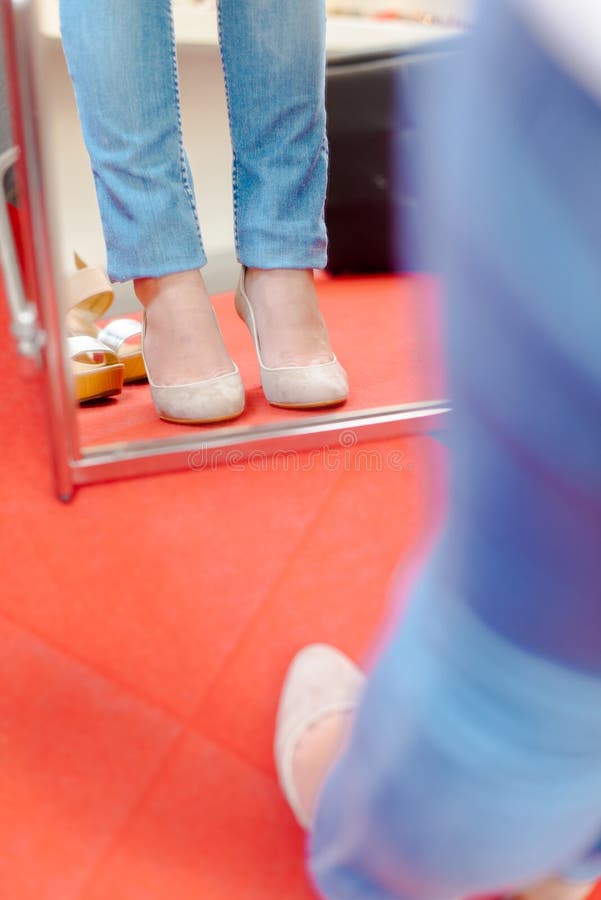 Checking shoes in mirror stock image. Image of wearing - 100880303