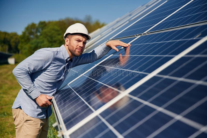 Checking the Surface. Engineer with Photovoltaic Solar Panels Outdoors ...