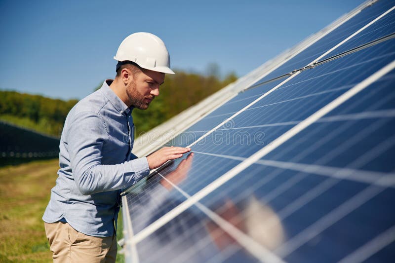 Checking the Surface. Engineer with Photovoltaic Solar Panels Outdoors ...