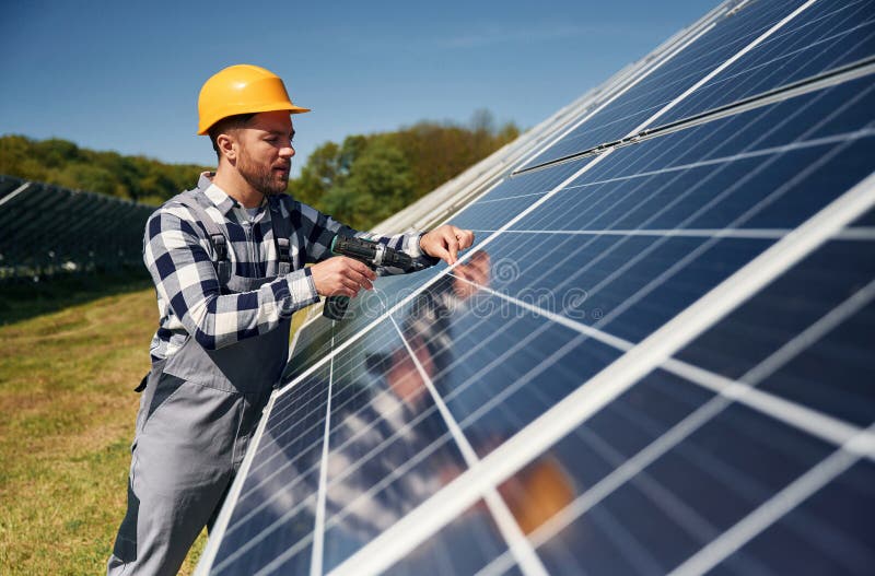 Checking the Surface. Engineer with Photovoltaic Solar Panels Outdoors ...