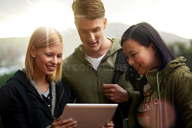 Checking Their Assignments Online. Three Young Students Looking at a ...