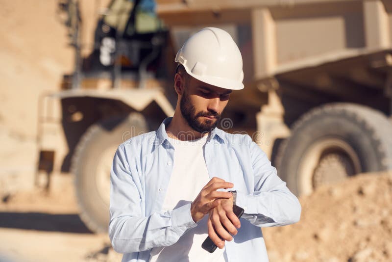 Checking Time. Man in Uniform is Working in the Quarry at Daytime Stock ...