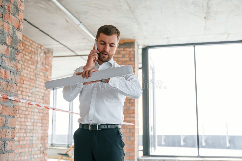 Checking the Time. Man in White Shirt is Working Indoors at ...