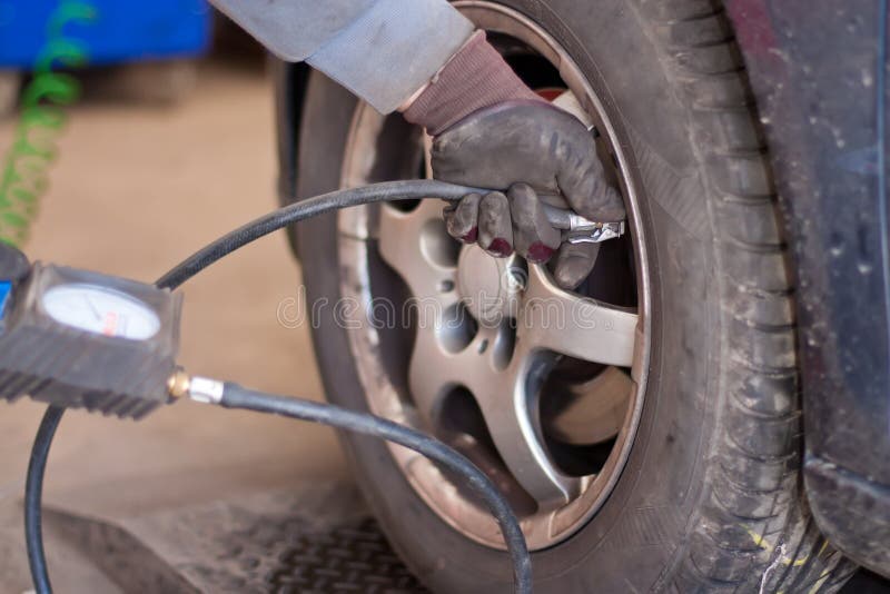 Checking the Tire Pressure at the Automobile Repair Shop Stock Image ...