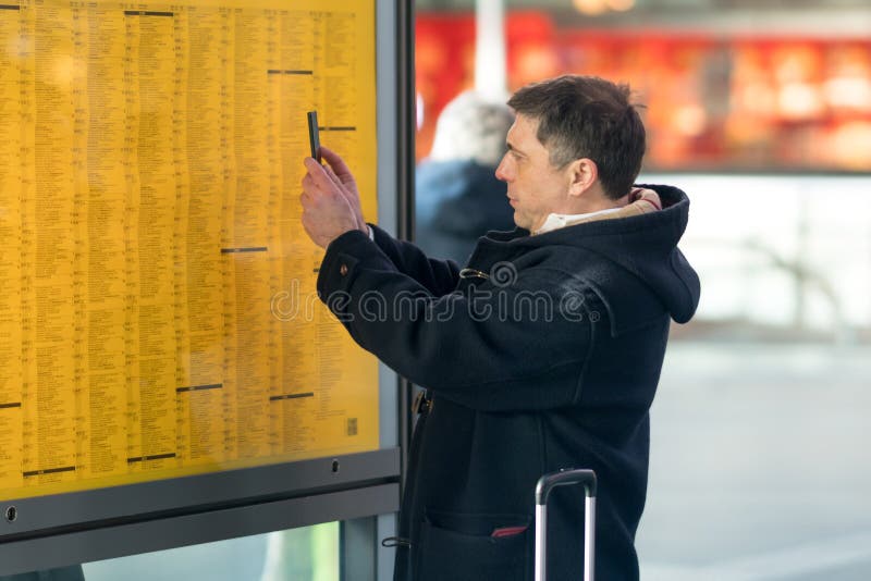Checking the Train Time Board at Railroad Station Stock Image - Image ...