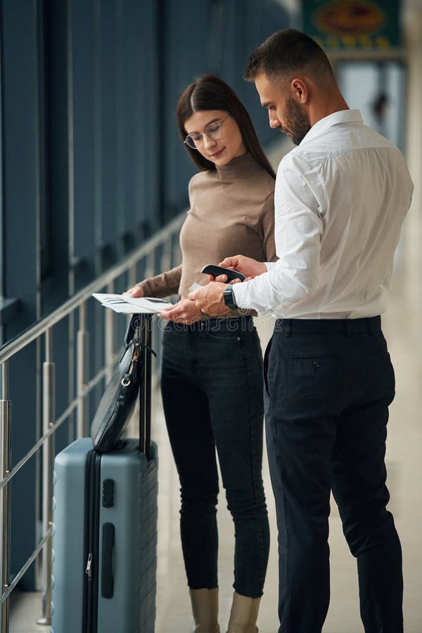 Checking the Valid Information. Woman is with Airport Worker, with ...