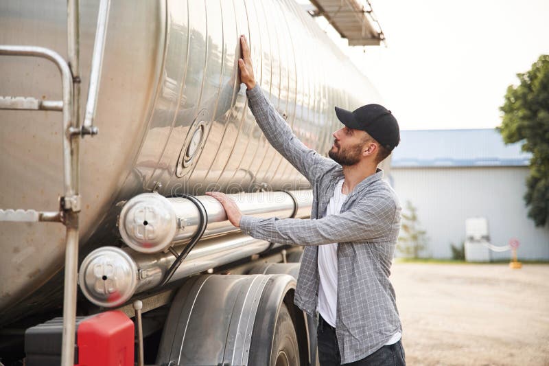 Checking the Vehicle Condition. Young Truck Driver in Casual Clothes ...
