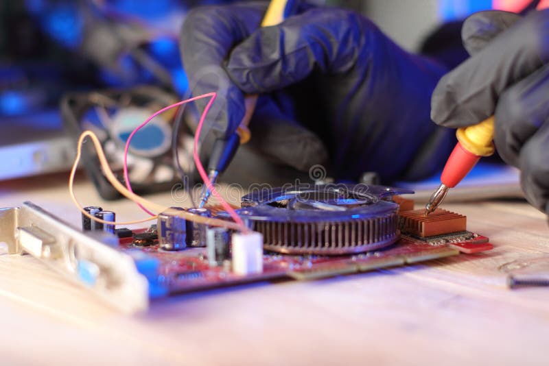 Checking the Voltage with an Ammeter in an Old Computer on the Table ...