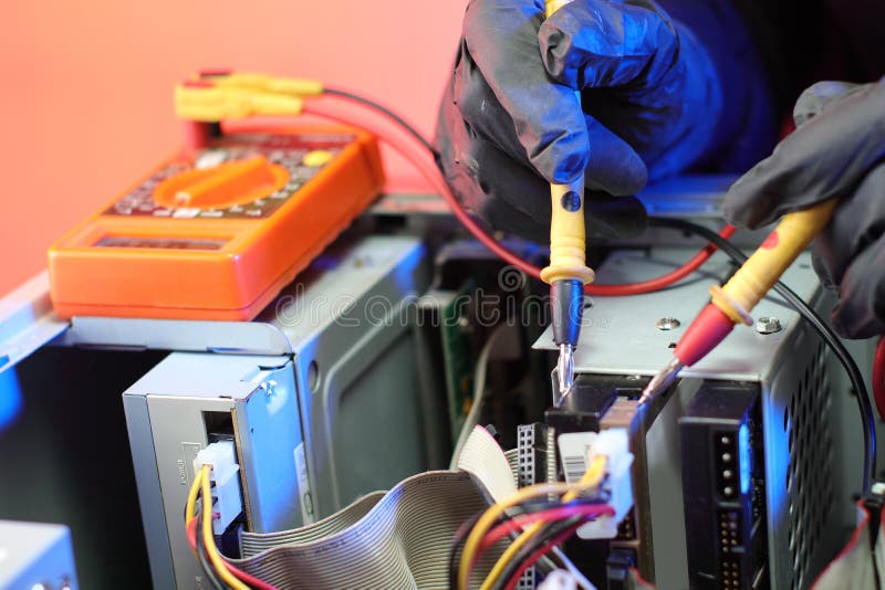 Checking the Voltage with an Ammeter in an Old Computer on the Table ...
