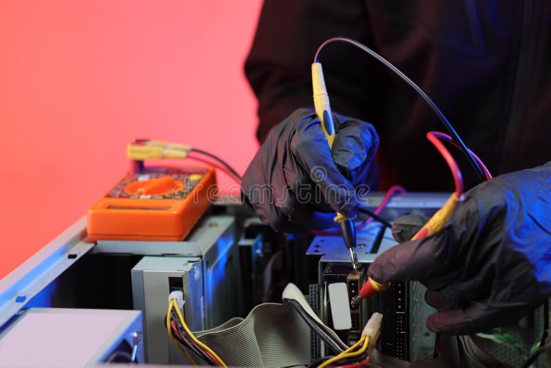Checking the Voltage with an Ammeter in an Old Computer on the Table ...