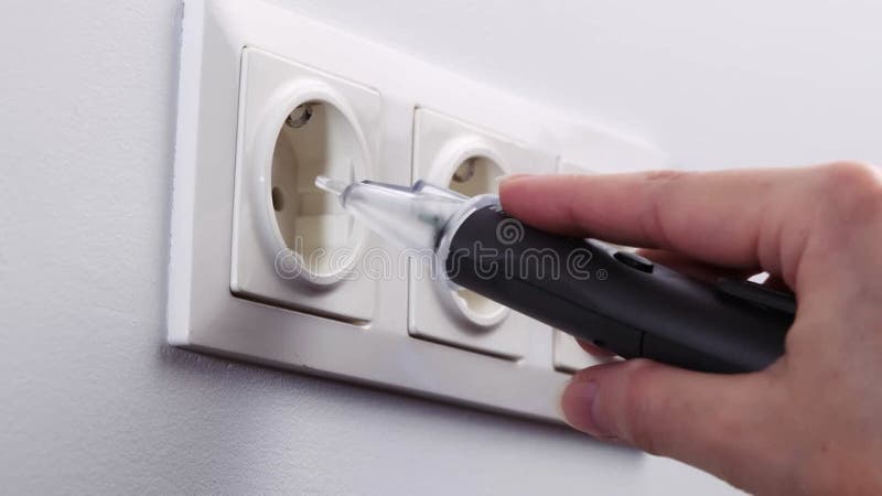 Checking the Voltage in the Socket Safe Contactless Tester. Electrician ...