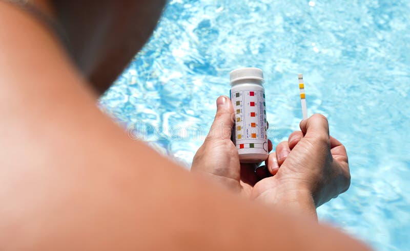 Checking the Water Quality of a Pool with the Help of a Test Strip with ...