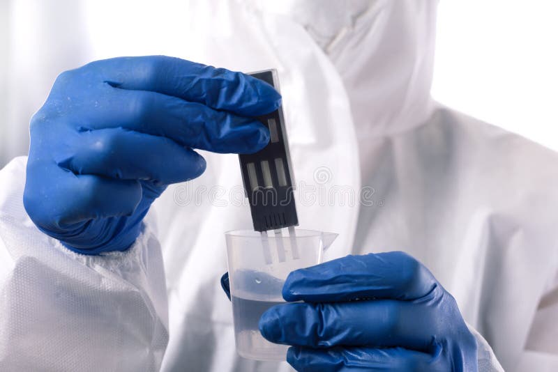 Checking the Water Quality. Scientist Dip a Test Strip into a Glass of ...