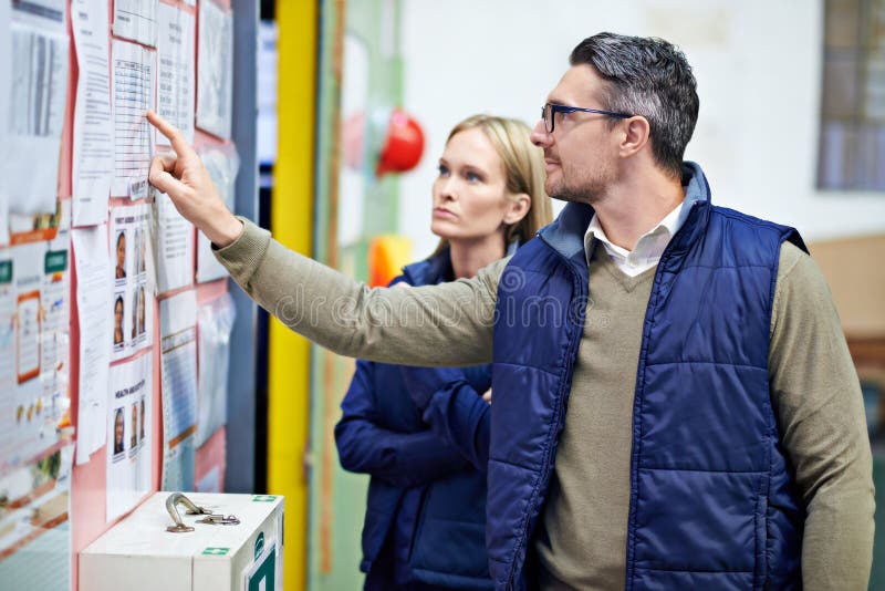 Checking the Weekly Work Updates. a Two Coworkers Managing a Warehouse ...