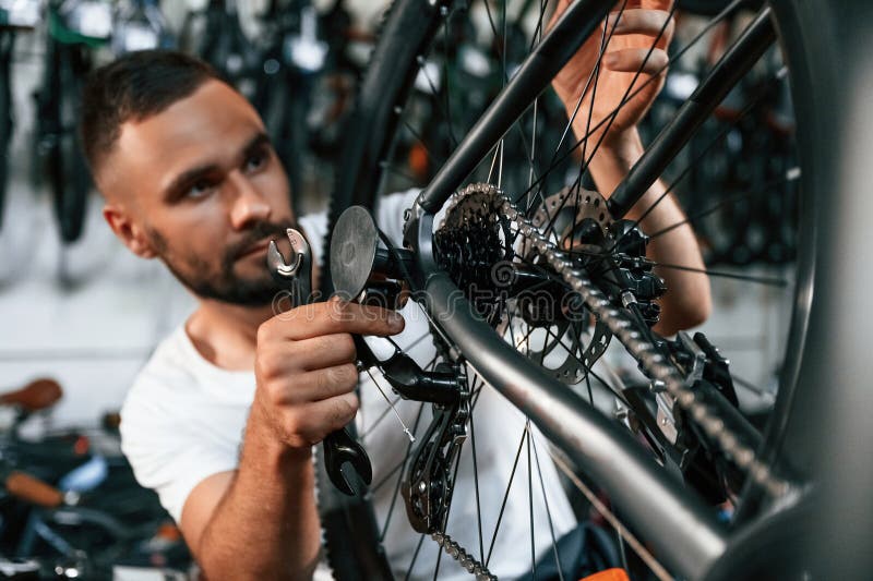 Checking the Wheel and Brake System. Repair Man in Bicycle Shop ...