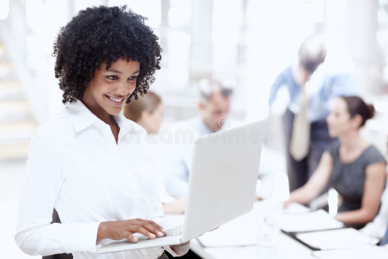 Checking Work Processes on the Laptop. an African Woman Using Her ...