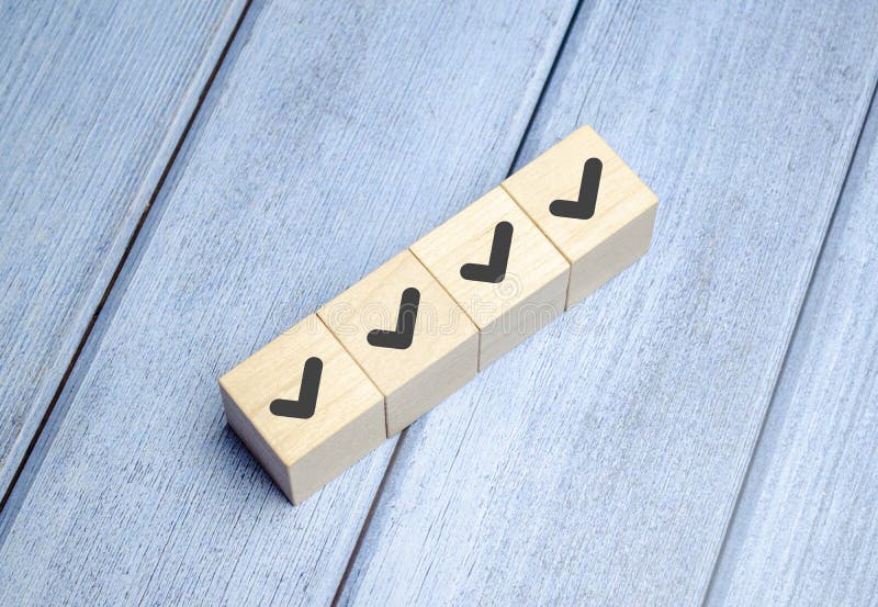 Checklist and Check Mark Concept. Check Mark on Wooden Blocks on Light ...