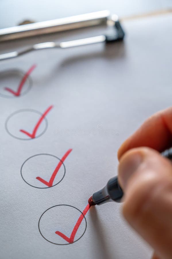 Checking Off a Checklist on a Clipboard on a Table Stock Image - Image ...