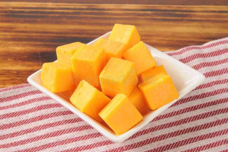 Cheddar cheese cubes stock image. Image of bowl, cheddar - 32668817
