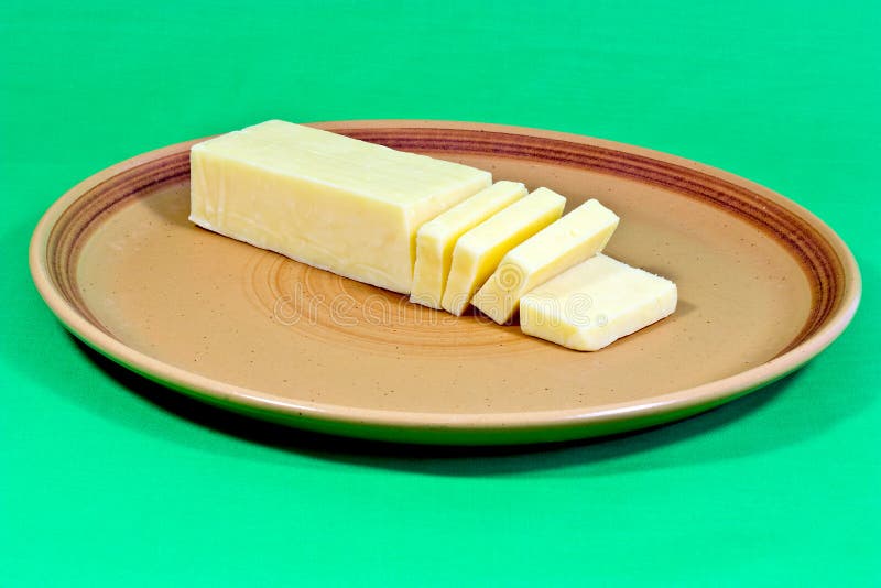 A Block of Cheddar Cheese Cut into Thick Slices. Stock Photo - Image of ...