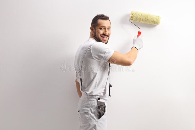 Cheeful House Painter Using a Paint Roller and Painting Stock Photo ...
