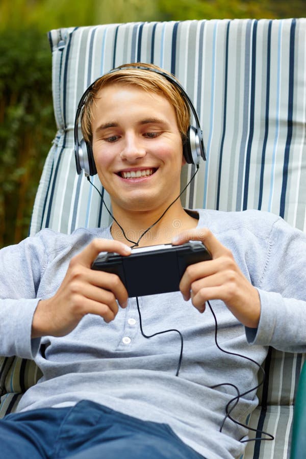 Cheeky youth playing games stock photo. Image of game - 32132768
