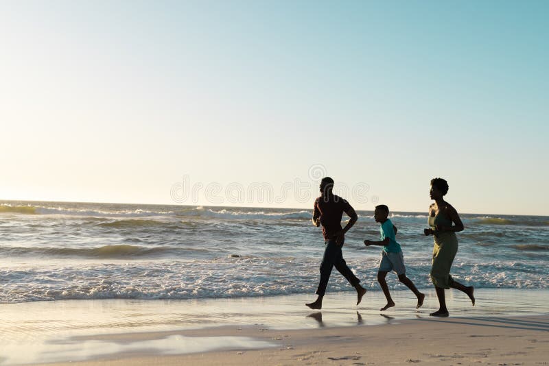 Cheerful African American Father and Mother with Son Running on Beach ... Cheerful African American Father and Mother with Son Running on Beach ...
