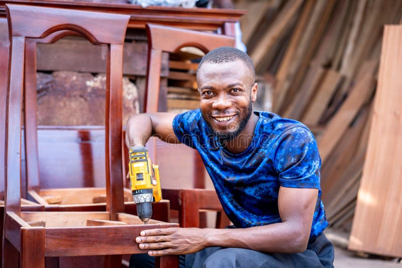 Cheerful African Man with a Drilling Machine Working in a Workshop ...