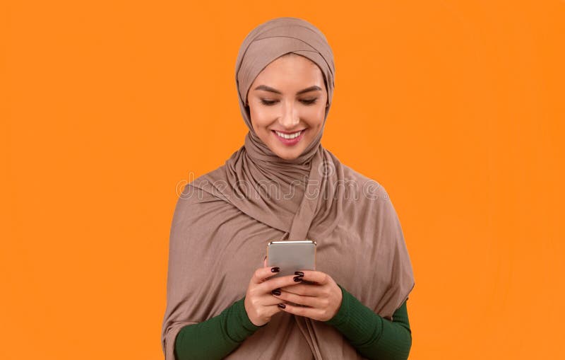 Cheerful Arabic Lady Using Mobile Phone Texting Standing Studio Stock ...