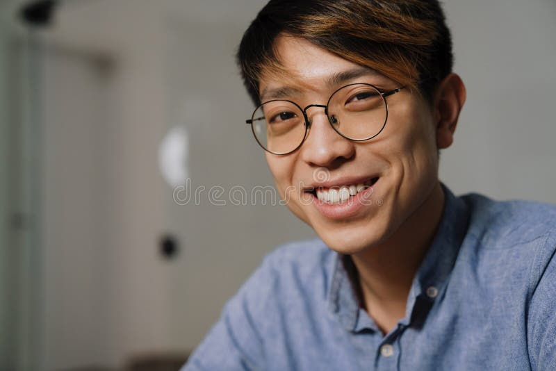 Cheerful Asian Guy in Eyeglasses Smiling while Working in Office Stock ...