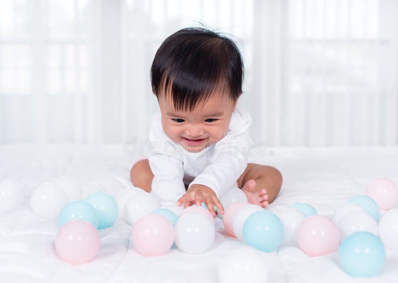 Cheerful Baby Playing Color Ball on Bed Stock Image - Image of cute ...