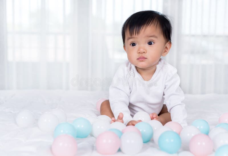 Cheerful Twin Babies Playing Color Ball on Bed Stock Photo - Image of ...