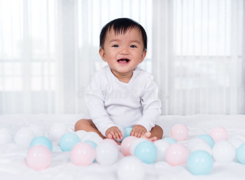 Cheerful Twin Babies Playing Color Ball on Bed Stock Photo - Image of ...