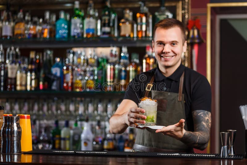 Cheerful Bartender Gives the Cocktail To Customer. Stock Image - Image ...