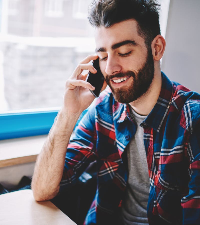 Cheerful Bearded Young Man Talking with Friend on Smartphone Using High ...