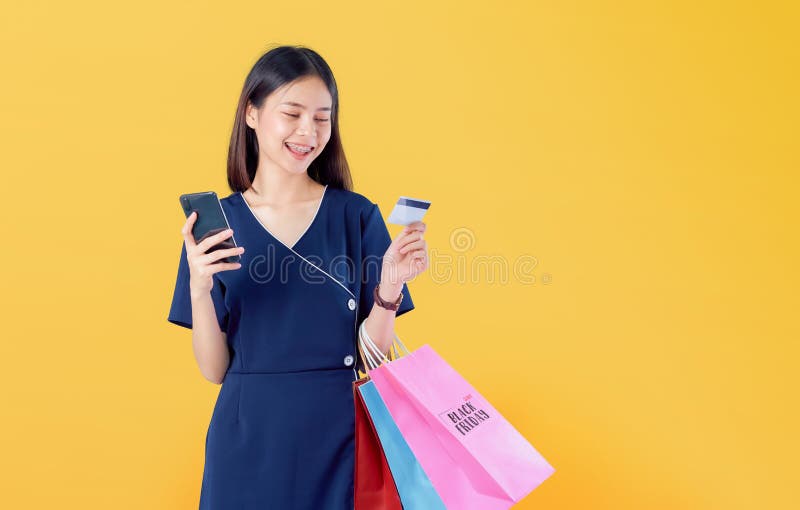 Cheerful Beautiful Asian Woman Holding Multi Coloured Shopping Bags And
