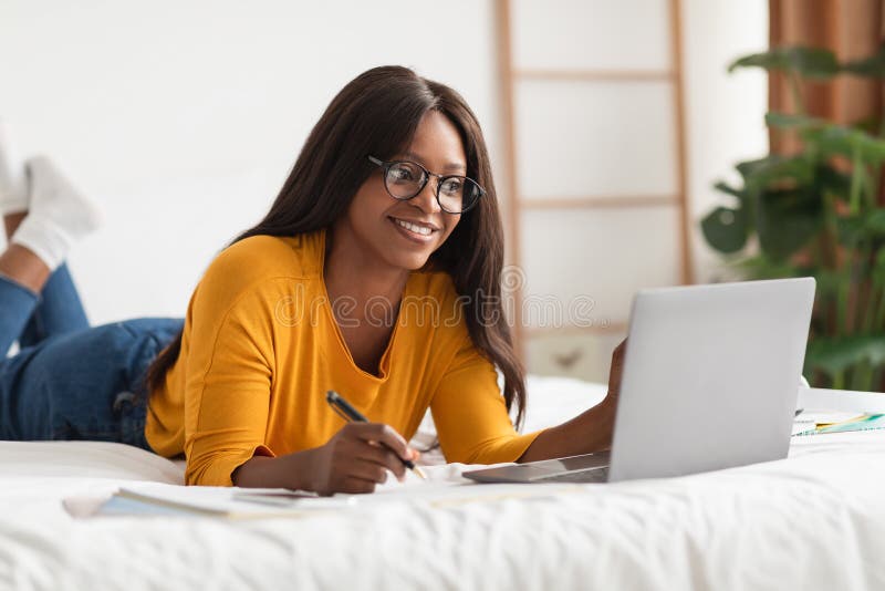 Cheerful Black Student Lady Using Laptop Taking Notes at Home Stock ...