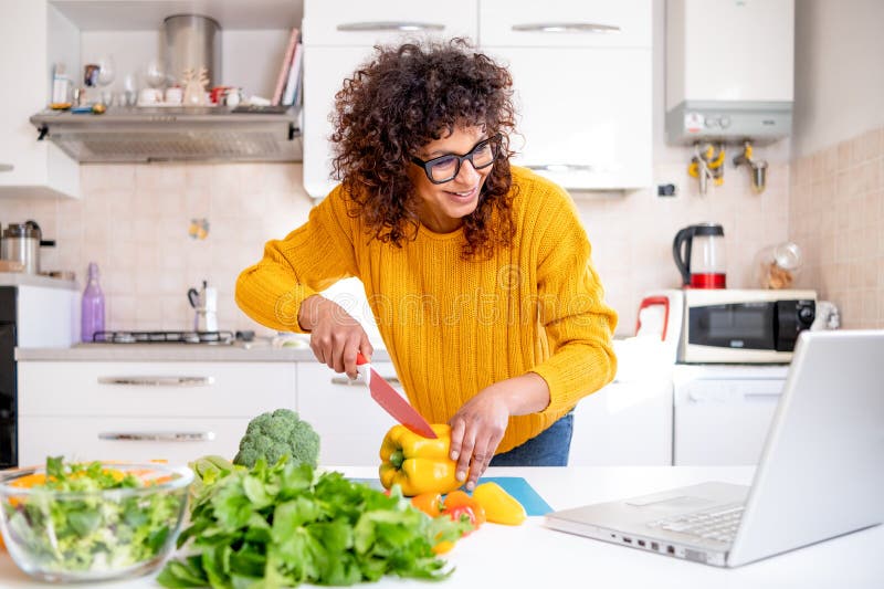 Cheerful Black Woman Learning To Cook at Home Watching Online Tutorial ...