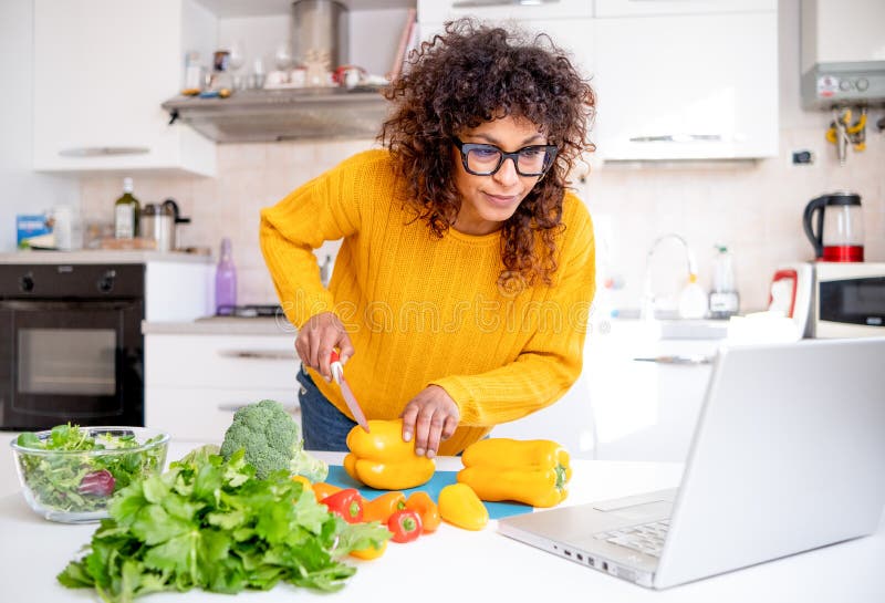 Cheerful Black Woman Learning To Cook at Home Watching Online Tutorial ...
