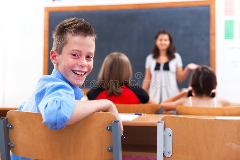 Confident Boy Sitting Alone in Classroom Stock Photo - Image of ...