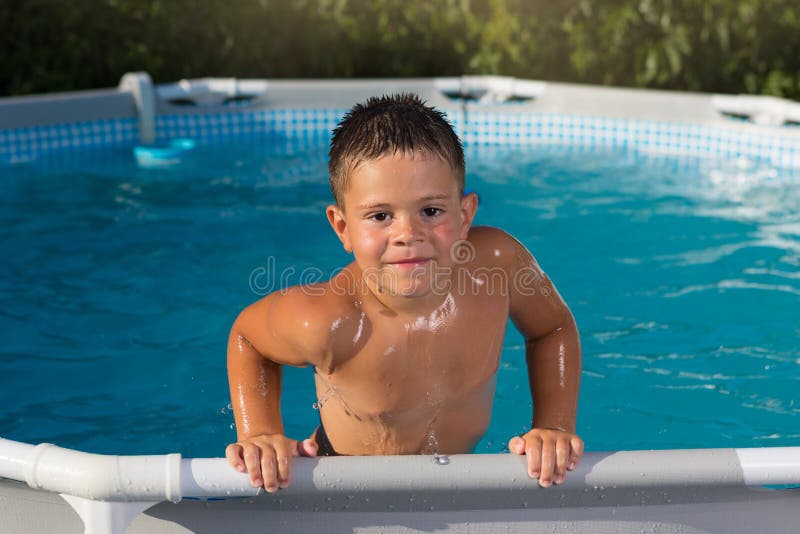 Cheerful Boy Climbs Out of the Pool, Leaning on the Edge of the Side ...
