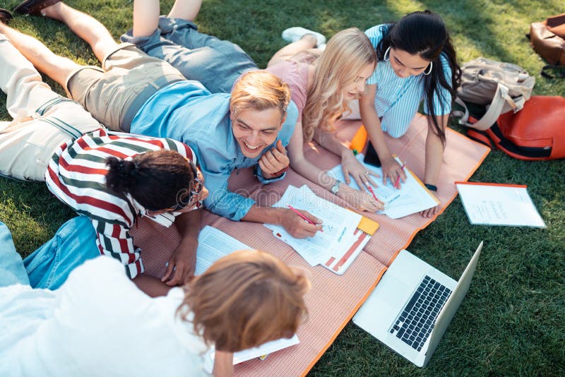 Cheerful Boy Doing Homework among His Friends. Stock Photo - Image of ...