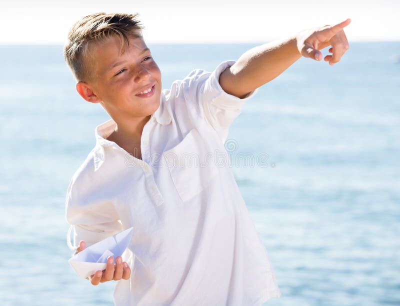 Boy pointing beach stock image. Image of elementary - 232235825
