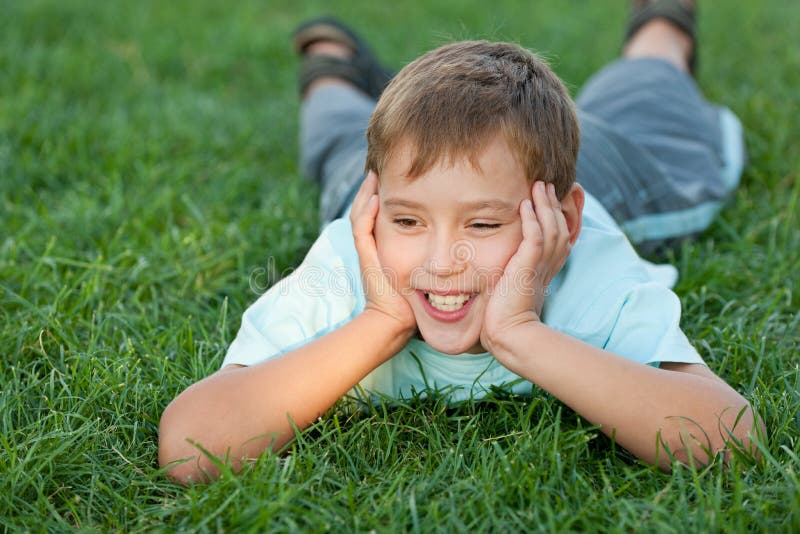 Cheerful Boy Lying on the Lawn Stock Image - Image of single, child ...